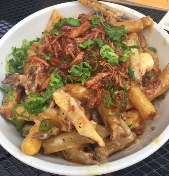 Poutine: Canada's greatest contribution to humanity besides politeness. Crispy fries swimming in gravy with cheese curds and pulled pork&mdash;comfort in a bowl.