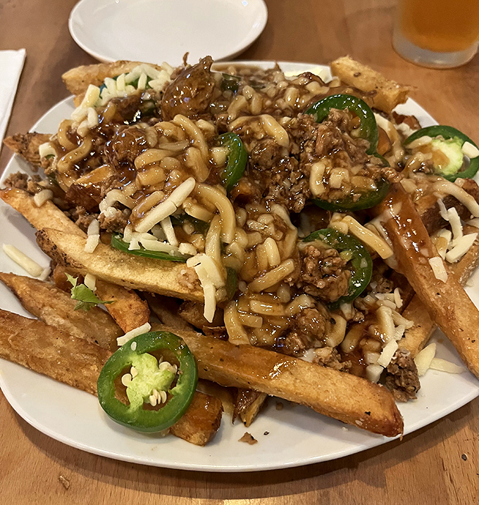 Loaded fries that would make a Canadian blush&mdash;crispy potatoes buried under savory meat, melted cheese, and jalape&ntilde;os for those brave enough to embrace the heat.