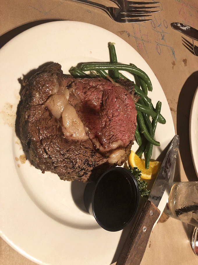 This prime rib isn't just cooked—it's been coaxed to perfection, with a blush of pink that would make a sunset jealous.