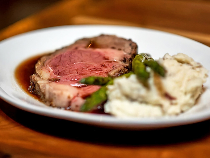 Prime rib perfection: rosy, tender meat bathed in savory au jus alongside creamy mashed potatoes. This is what food dreams are made of.