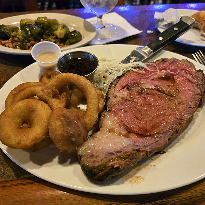 The star of the show: prime rib cooked to a perfect medium-rare, accompanied by golden onion rings that shatter with each bite.