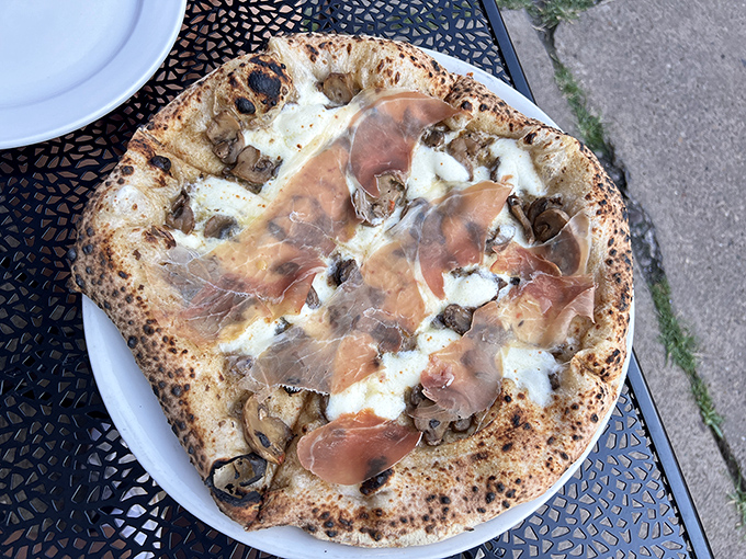 Prosciutto draped like silk over mushrooms and mozzarella. This isn't just dinner; it's edible architecture with a PhD in deliciousness.