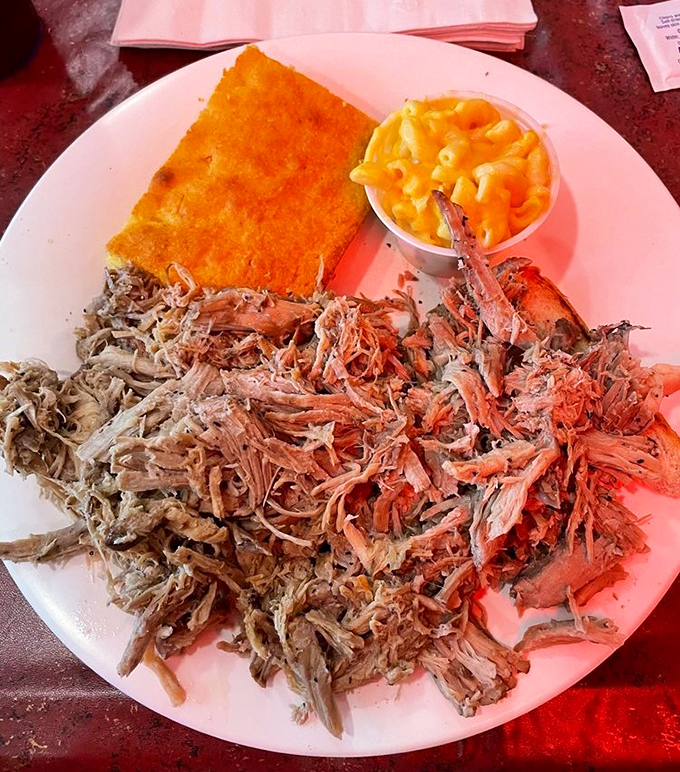 Pulled pork so tender it practically surrenders to your fork, served with cornbread and mac & cheese that demand equal attention.