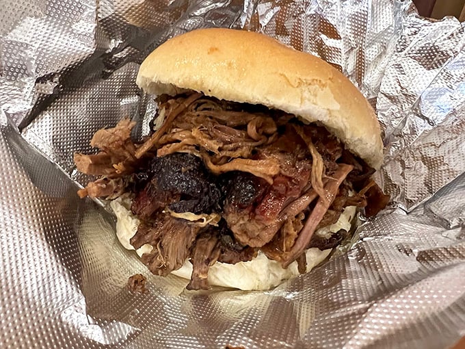 This pulled pork sandwich isn't just food—it's edible evidence that good things come to those who wait... and smoke... and season just right.