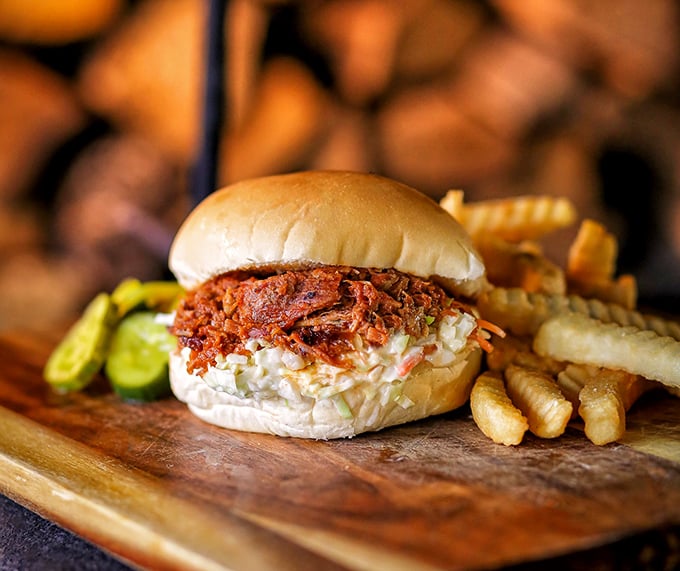 The pulled pork sandwich: where coleslaw and meat perform a dance so beautiful it should require tickets.