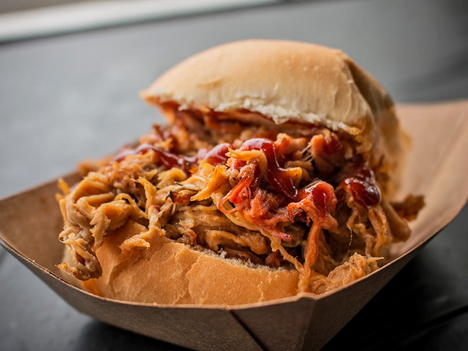 The pulled pork sandwich that launched a thousand road trips. That bark-to-meat ratio would make even Carolina pit masters nod in respectful approval.