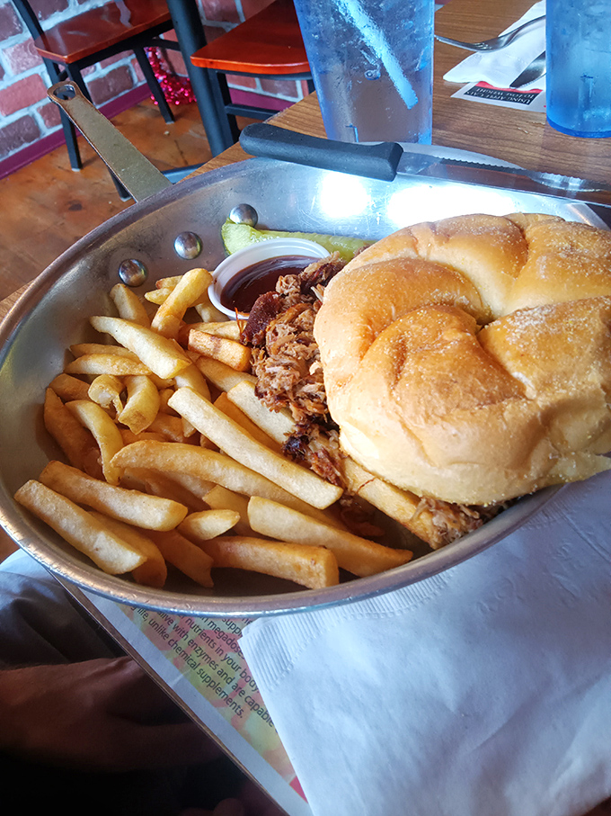 A pulled pork sandwich that demands both hands and several napkins. The fries aren't a side dish&mdash;they're co-stars in this comfort food production.