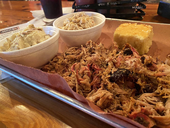 Pulled pork perfection on display with creamy sides and cornbread. This isn't just dinner &ndash; it's edible therapy after a long Michigan winter.