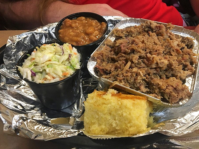 A BBQ plate that hits all the right notes: pulled pork with perfect bark bits, creamy slaw, golden cornbread, and beans that didn't come from any can.