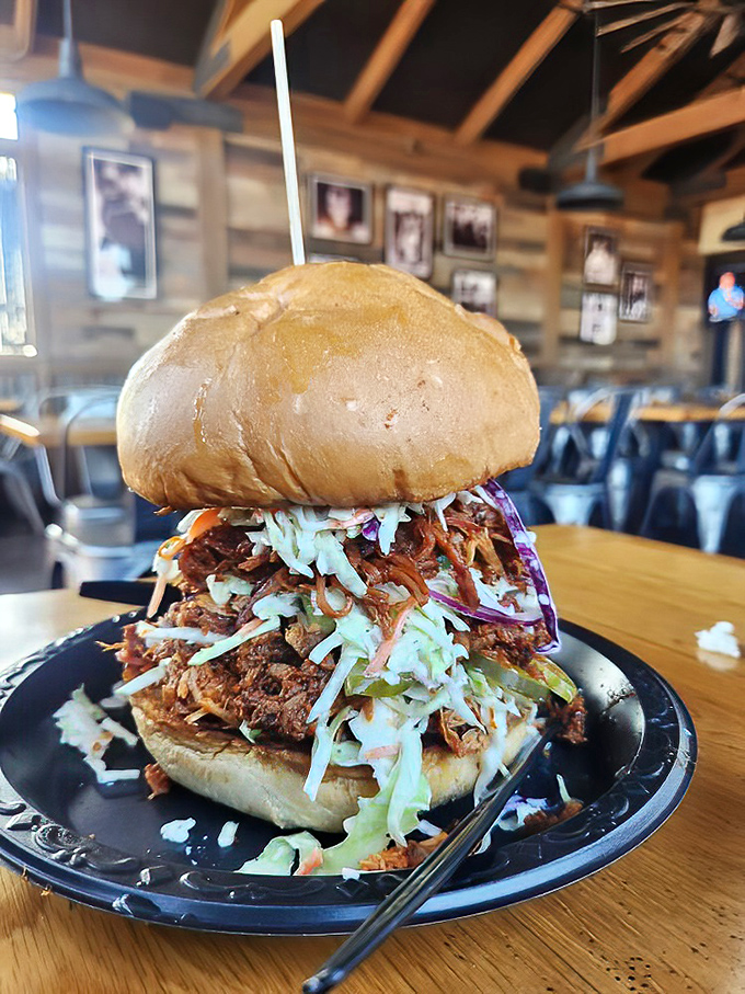 This pulled pork sandwich isn't just a meal, it's an architectural marvel &ndash; a delicious Jenga tower of meat, slaw, and bun that dares you to find a dignified way to eat it.