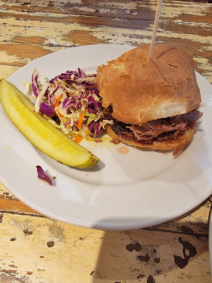 A sandwich that demands both hands and your full attention, served with coleslaw that's actually worth eating. No sad deli pickle here!