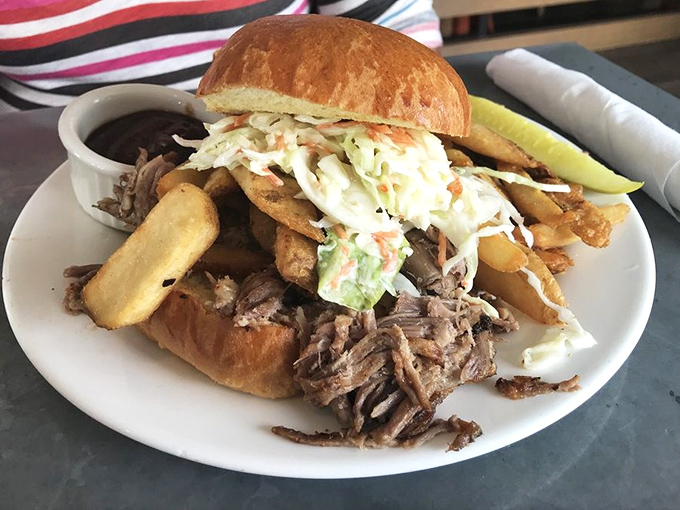 This pulled pork sandwich isn't just lunch&mdash;it's an architectural marvel of meat, slaw, and crispy fries.