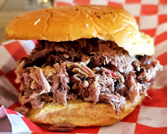 A proper pulled pork sandwich should require both hands and several napkins. This mountain of smoky, tender meat on a soft bun passes the test with flying colors.