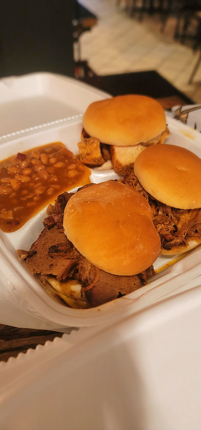 Slider heaven! These mini sandwiches and baked beans prove that sometimes the best things come in small, smoky packages.