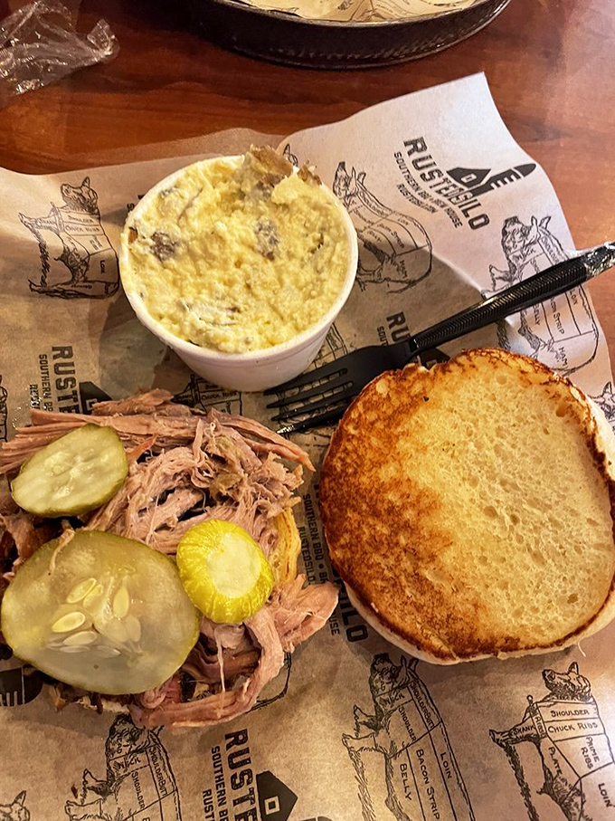 This pulled pork sandwich, adorned with pickles and paired with mac and cheese, isn't just lunch&mdash;it's an edible love letter to Southern tradition.