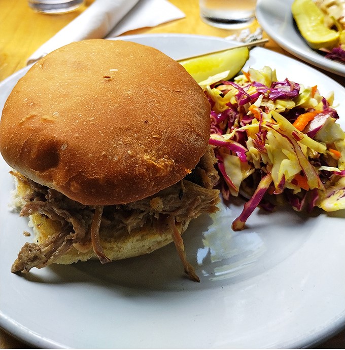 This pulled pork sandwich isn't just a meal, it's an event &ndash; tender meat on a fresh-baked bun with house-made slaw that adds crunch and color.