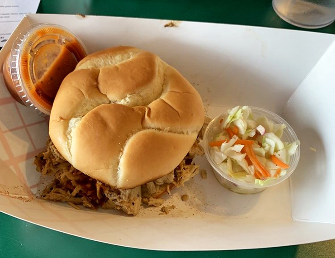 The pulled chicken sandwich sits proudly on its throne, flanked by loyal subjects of coleslaw and sauce&mdash;a humble monarch of lunch options.