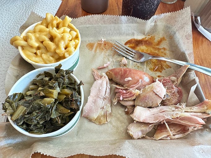 The holy trinity of Southern comfort: pulled chicken, mac and cheese, and collard greens. This isn't a meal; it's a warm hug from your grandmother, if she smoked meat for a living.