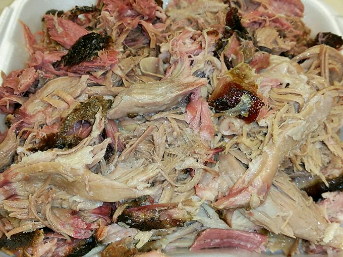 Pulled pork that looks like it's been coaxed apart by angels. The bark mixed with tender strands creates a textural symphony that makes forks everywhere feel purposeful.
