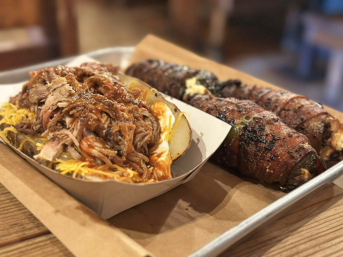 A loaded potato with pulled pork alongside ribs&mdash;proof that in Texas, "portion control" means controlling how many portions you can fit on one tray.