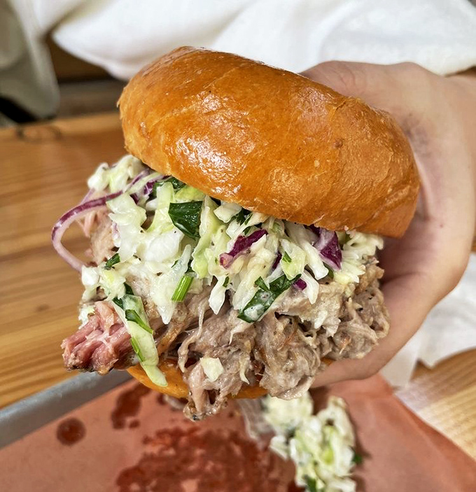 This pulled pork sandwich isn't just a meal, it's an event &ndash; tender strands of smoky pork crowned with fresh slaw on a pillowy bun.