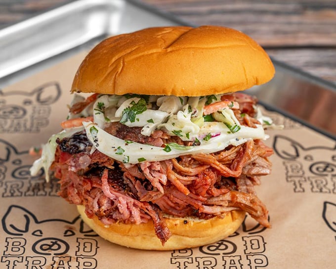 This isn't just a sandwich; it's an architectural marvel of pulled pork. The slaw provides a cooling counterpoint to the meat's smoky intensity, like the yin to barbecue's yang.