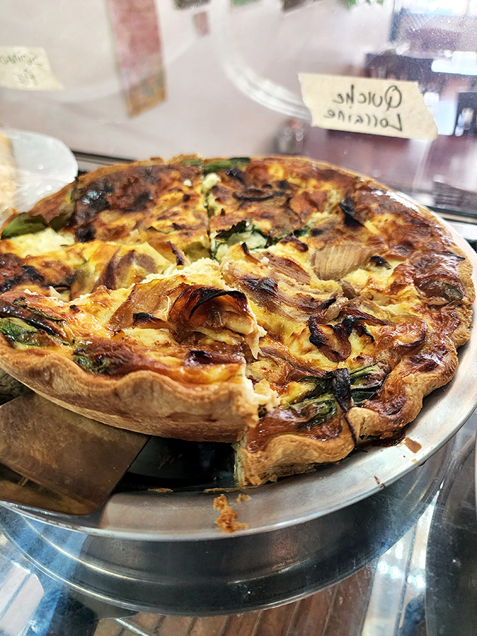 This quiche isn't just having a moment, it's throwing a full-blown party of caramelized onions and spinach beneath that golden crown of cheese.
