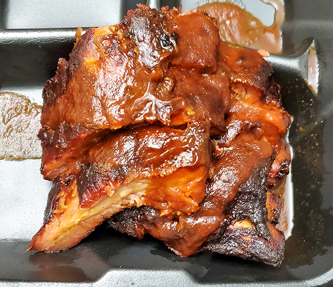 These ribs have the kind of bark that makes tree bark jealous. The glistening meat has clearly been having a long, intimate conversation with smoke and spices.
