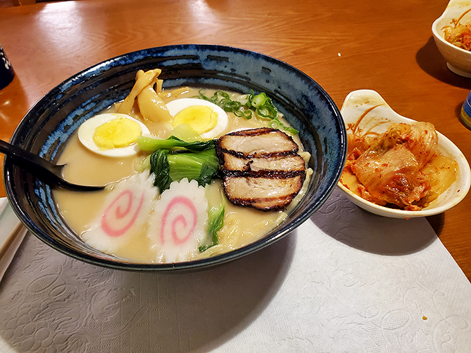 This ramen bowl isn't just soup&mdash;it's a swimming pool of comfort with those playful pink swirls, tender pork, and an egg that's achieved celebrity status in the yolk world.