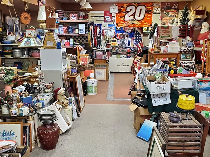 NASCAR meets Santa Claus in this booth where memorabilia mingles with holiday decor. The narrow pathway between treasures feels like a scavenger hunt designed by maximalists.