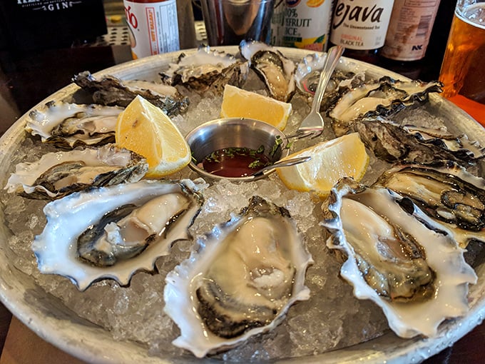 Fresh oysters on ice looking like oceanic jewels waiting for their close-up and cocktail sauce dance.