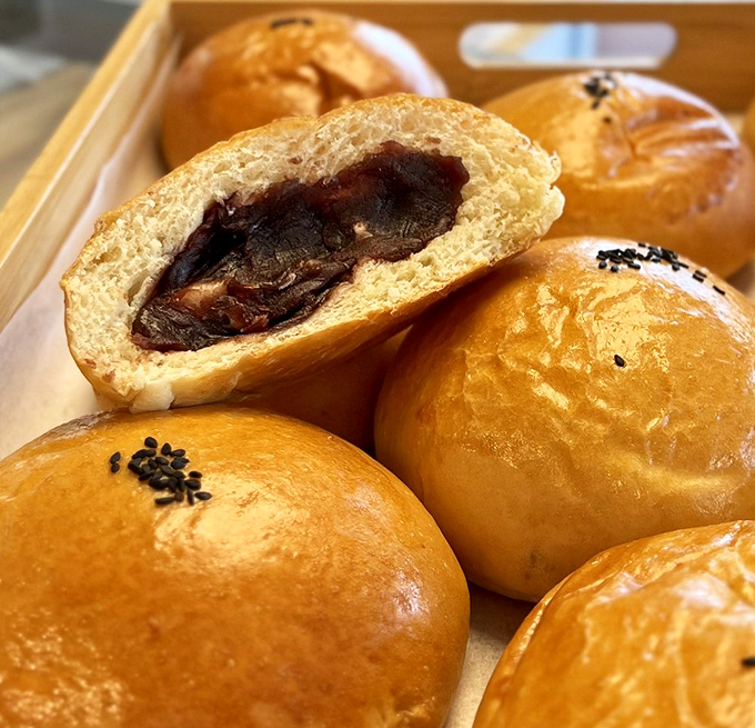 These red bean buns hide their sweet, earthy treasure inside golden exteriors—like edible gift boxes waiting to be unwrapped with each bite.