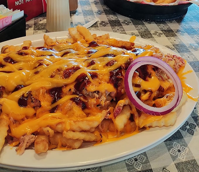 Redneck Fries: where french fries meet pulled pork, cheese, and BBQ sauce in a glorious union that makes you wonder why you'd eat fries any other way.
