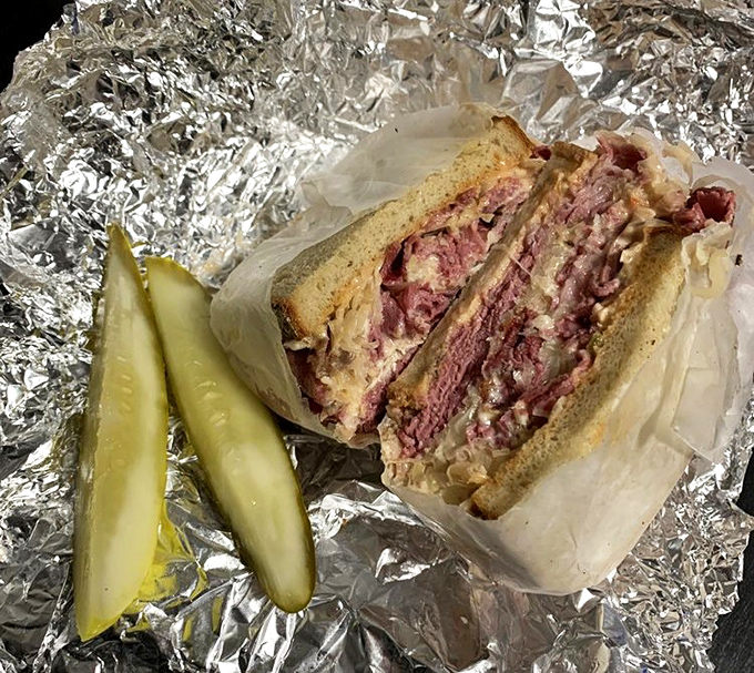 The Reuben that launched a thousand food dreams. Perfectly grilled rye bread embraces corned beef, sauerkraut, and Swiss in this classic deli masterpiece.