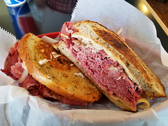 This Reuben isn't just a sandwich; it's architecture. Layers of corned beef and sauerkraut creating the skyscraper Frank Lloyd Wright would have eaten.
