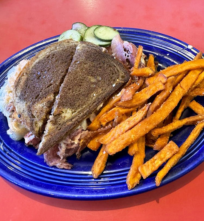 The Reuben arrives like a sandwich superhero &ndash; cape optional, sweet potato fries mandatory, satisfaction guaranteed.