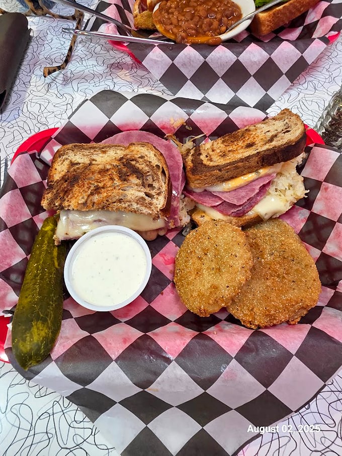 A proper Reuben should require strategic napkin deployment. This beauty, with its melty cheese cascade, passes the test with flying colors.