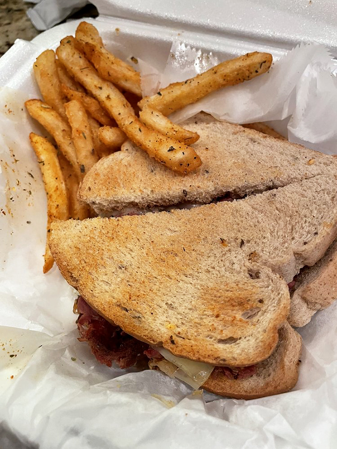 The humble Reuben, elevated to art form with perfectly toasted bread and seasoned fries that whisper, "Yes, you deserve this."