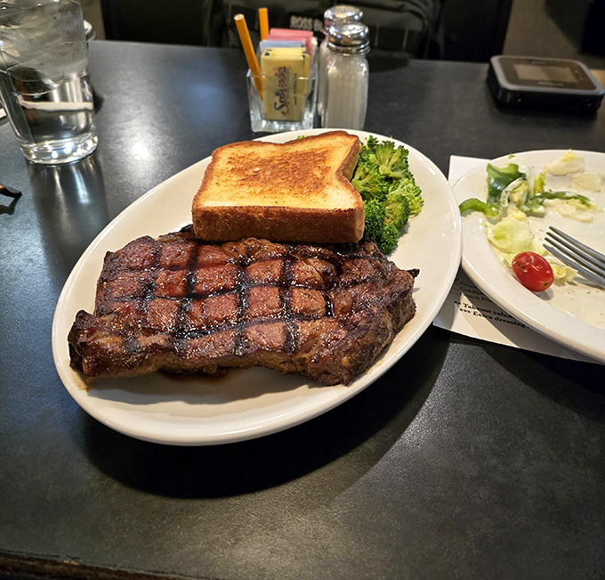 This ribeye isn't just grilled&mdash;it's been coaxed to perfection, sporting grill marks that deserve their own Instagram account.
