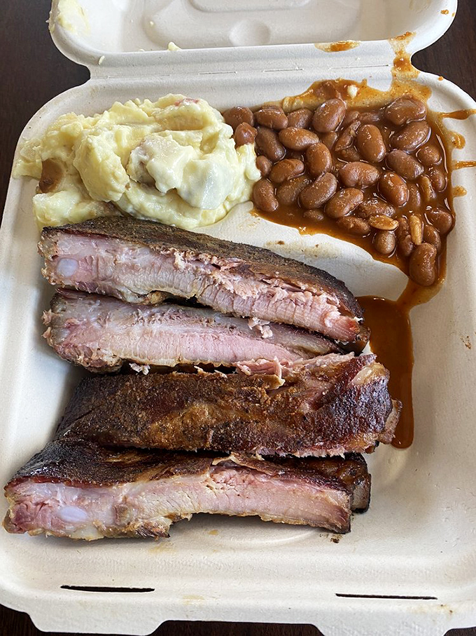 These ribs with potato salad and beans aren't just a meal&mdash;they're edible evidence that patience and smoke create miracles worthy of religious devotion.