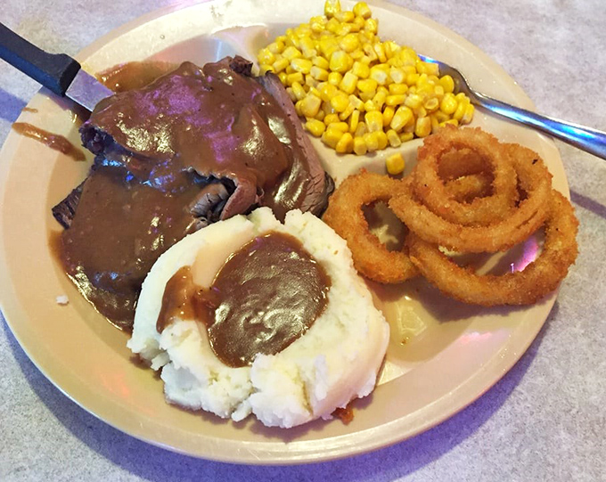 Comfort food that would make your grandmother both jealous and proud. That gravy pool isn't just sauce—it's liquid therapy after a long day.