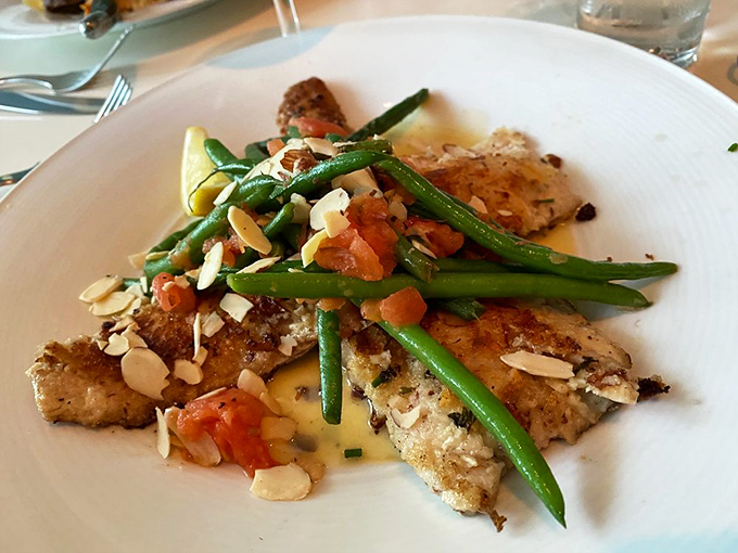 Perfectly seared fish with vibrant green beans and toasted almonds&mdash;proof that the French know simplicity is the ultimate sophistication.
