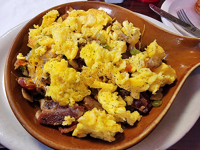 Breakfast alchemy at its finest&mdash;eggs, meat, and vegetables performing a morning symphony in a skillet that's seen more action than a Western movie.