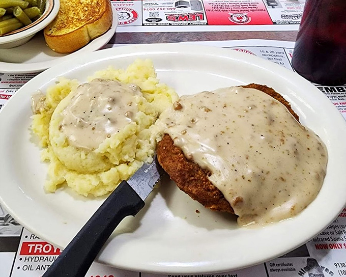 Country-fried comfort smothered in peppery gravy alongside fluffy mashed potatoes. The kind of meal that makes you want to hug the chef afterward.