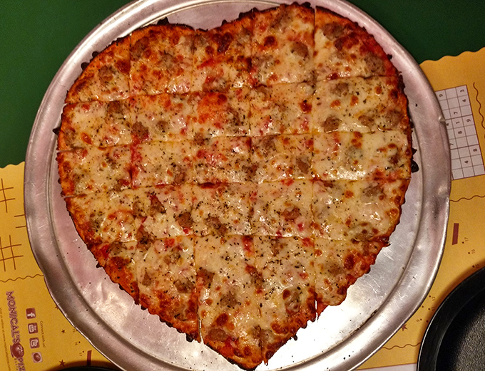 Heart-shaped pizza perfection that proves love isn't just an emotion – sometimes it's a perfectly cut tavern-style thin crust with bubbling cheese.