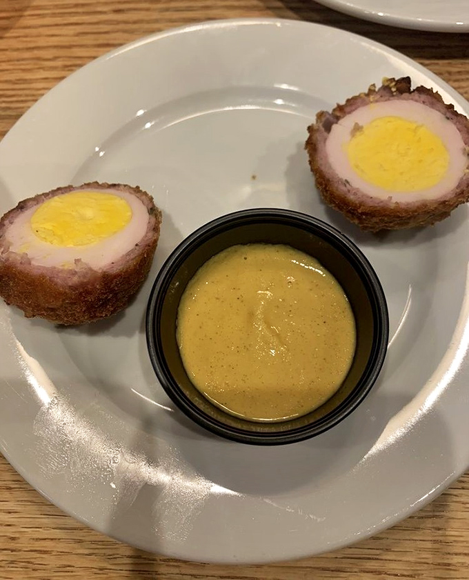 The humble Scotch egg, elevated to art form. Perfectly runny yolk encased in seasoned ground pork and a crispy exterior &ndash; Britain's greatest contribution to handheld food.