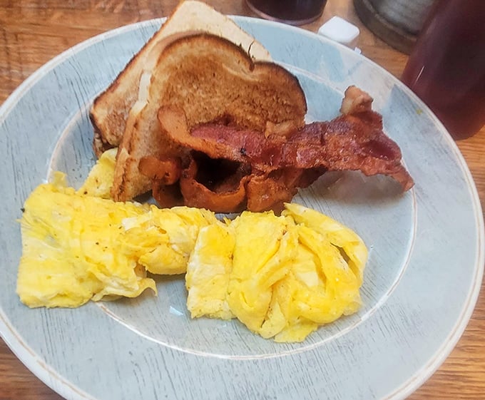 Breakfast perfection doesn't need to be complicated. Golden scrambled eggs, crispy bacon, and toast&mdash;the holy trinity of morning bliss done exactly right.