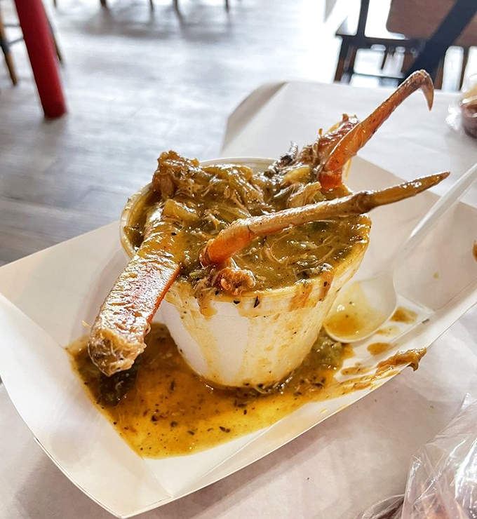 Seafood gumbo so rich it should have its own tax bracket, with crab legs reaching skyward like they're trying to escape. They won't.