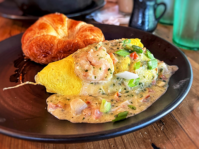 Breakfast alchemy: golden omelet, buttery croissant, and plump shrimp dancing in a sauce that would make Neptune himself request seconds.