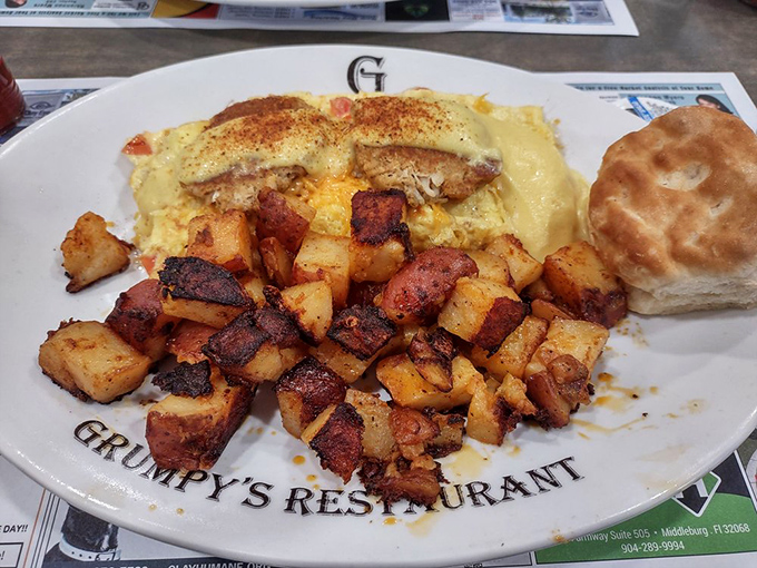 Breakfast architecture at its finest: a golden seafood omelet, crispy potatoes, and a biscuit standing guard&mdash;the holy trinity of morning satisfaction.